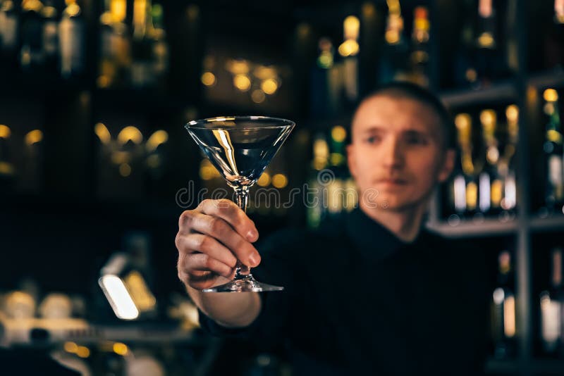 Barman Watches a Crystal Glass. the Bartender Cleaning the Glass on the ...