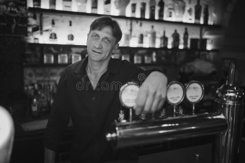 Barman at work in the pub stock photo. Image of restaurant - 75158874