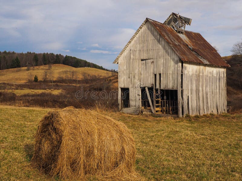 Barn and Hay Roll stock photo. Image of meadow, rustic - 83768486