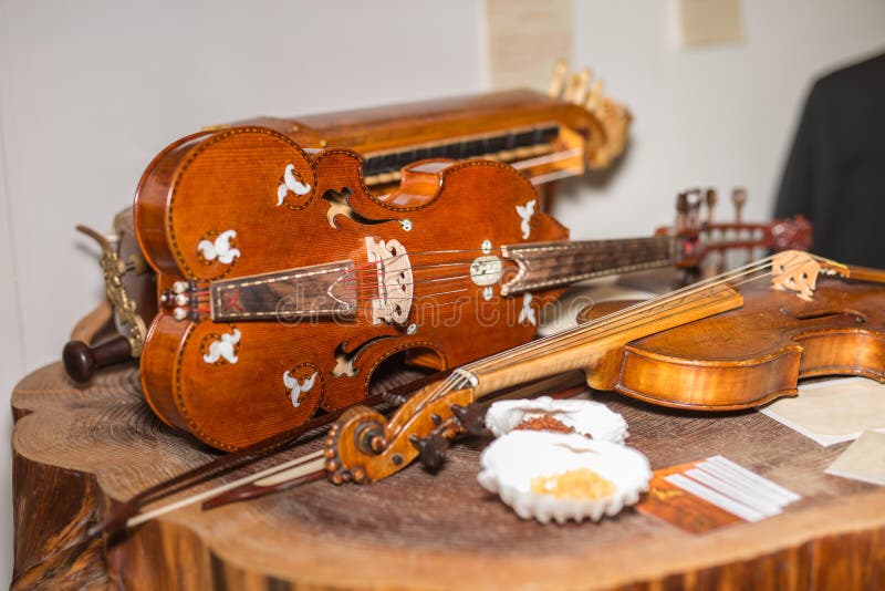 Baroque Wooden Violin on a Tree Trunk Near Other Instruments Stock ...