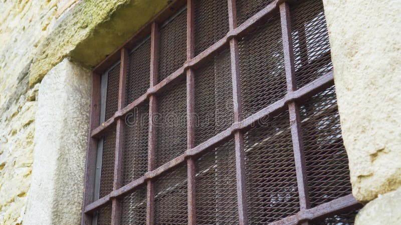 Prison Building Wall with Barred Windows of Prison Cells Behind an Iron ...