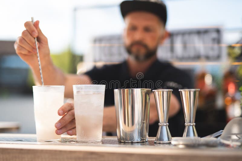 The Bartender Behind the Bar Makes an Alcoholic Cocktail Stock Photo ...