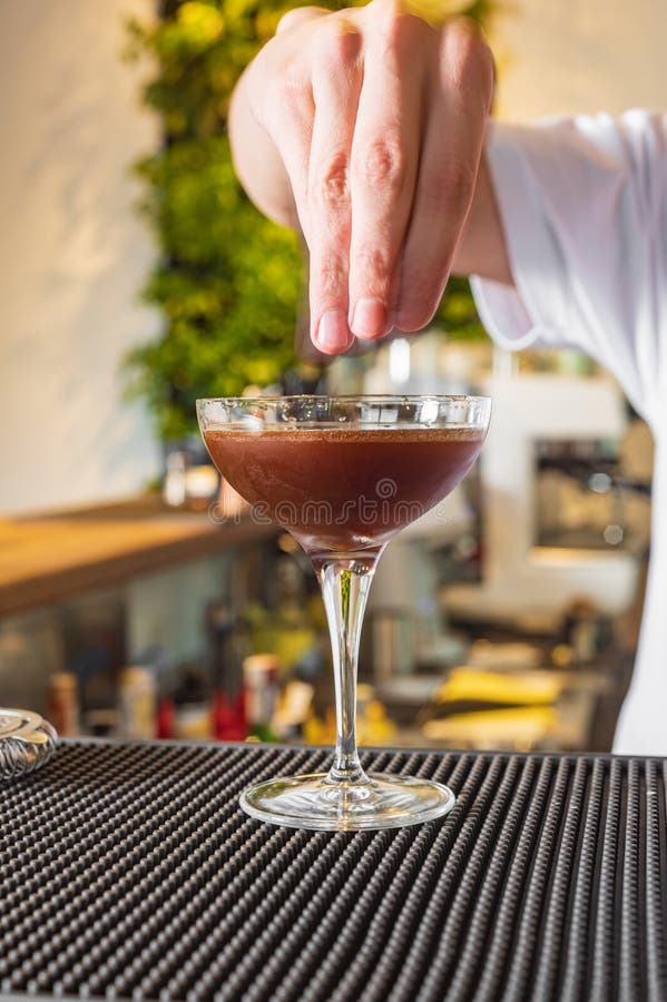 The Bartender Behind the Bar Makes an Espresso Martini Stock Image ...