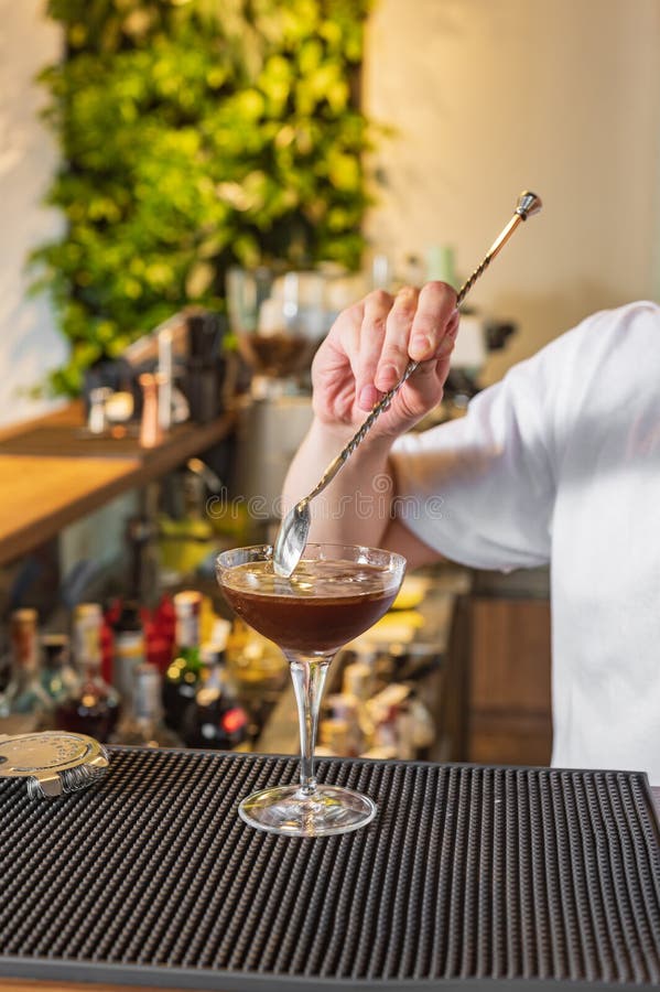 The Bartender Behind the Bar Makes an Espresso Martini Stock Image ...
