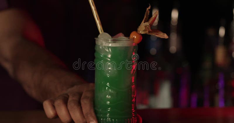 The Bartender Behind the Bar is Moving the Ready Cocktail for the Guest ...
