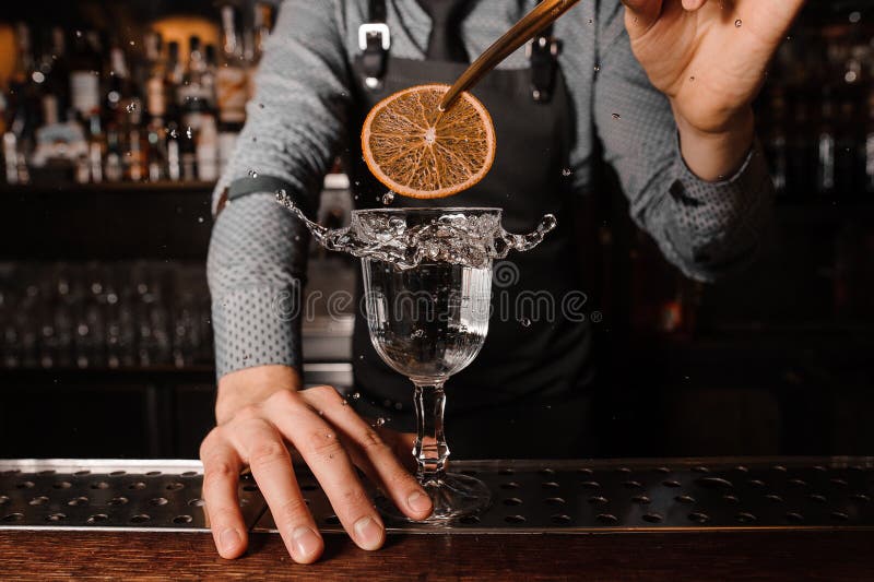 Bartender Decorating a Clear Alcoholic Drink with a Slice of Lemon ...