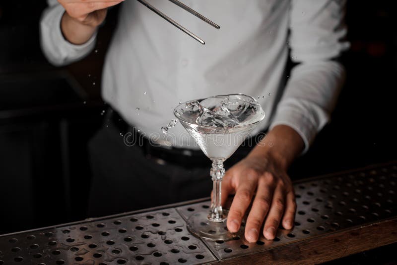 Bartender Dropping an Olive into the Martini Glass Stock Photo - Image ...