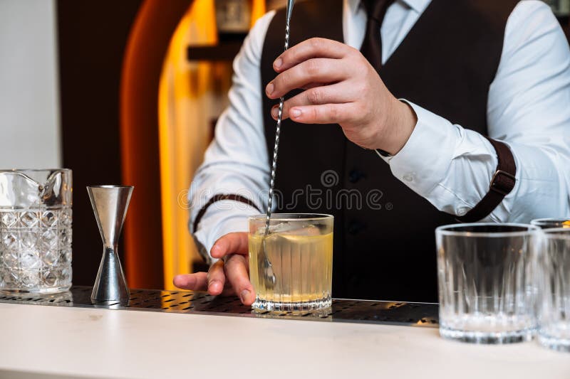 Bartender Preparing a Cocktail at a Stylish Bar during an Evening Event ...