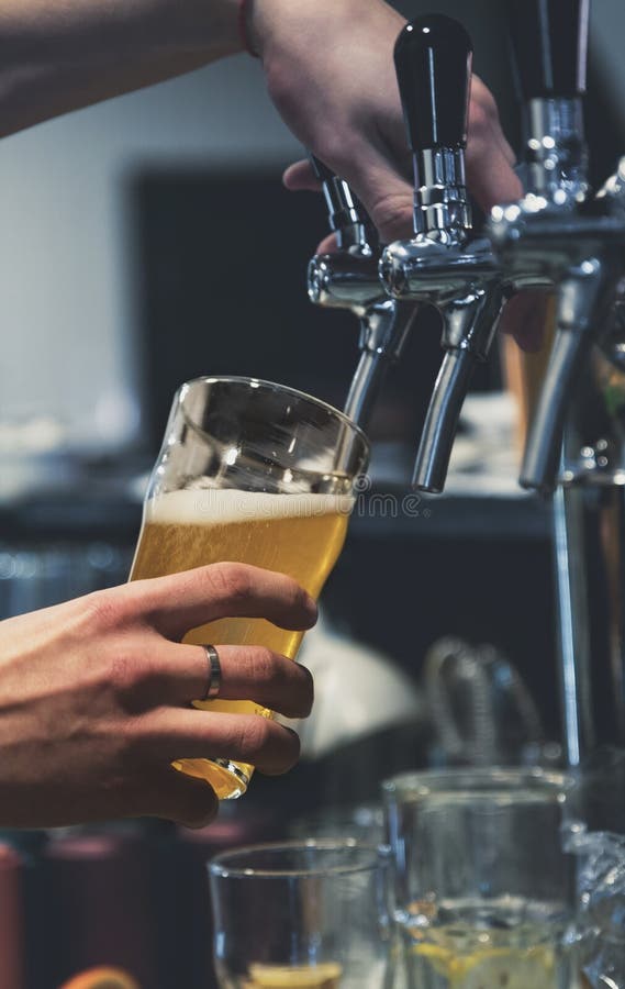 Bartender Hand at Beer Tap Pouring a Draught Beer in Glass Stock Photo ...
