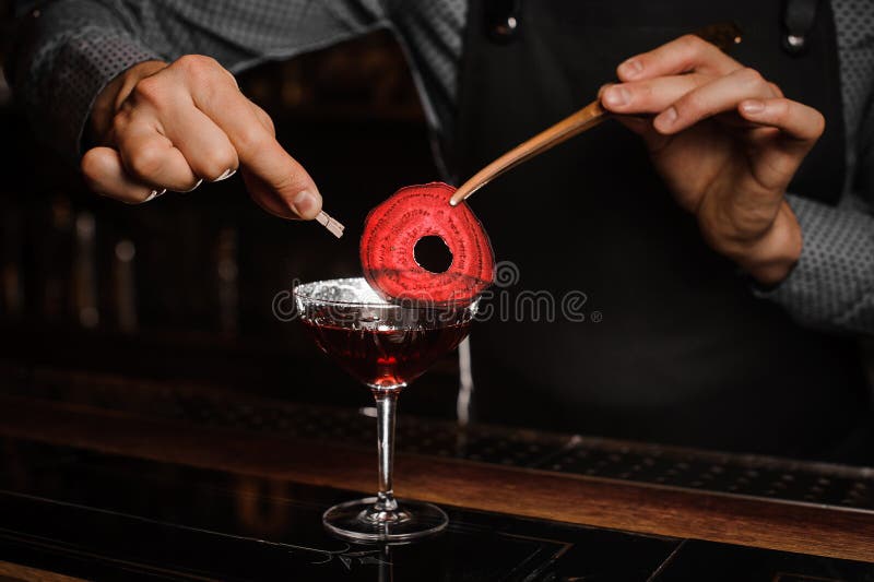 Bartender Hands Decorating a Red Cocktail Drink with a Slice of a Beet ...