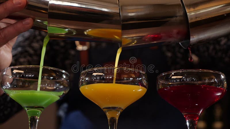 Bartender Hands Pouring Three Colored Cocktails Simultaneously Stock ...
