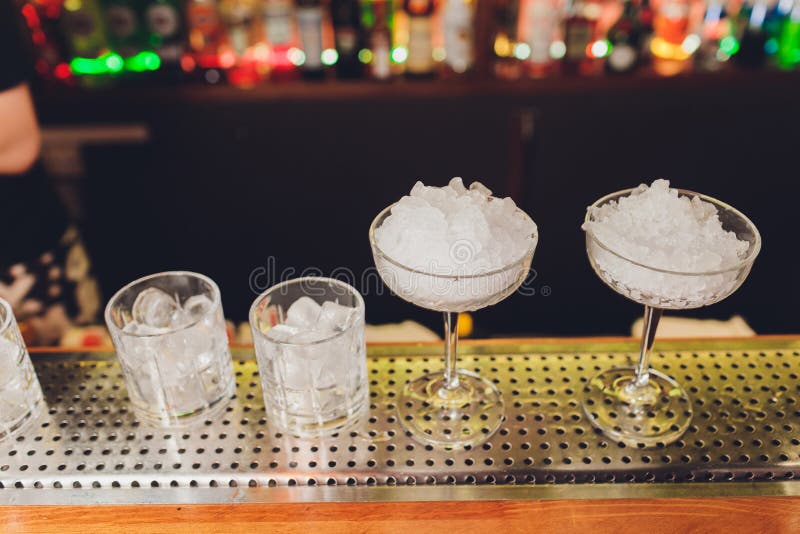 A Bartender Makes a Cocktail Over the Marble Bar Counter. Stock Image ...