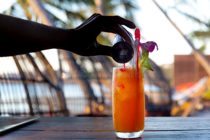 Bartender Making Cocktail at the Bar on the Beach and Adding Liquid in ...