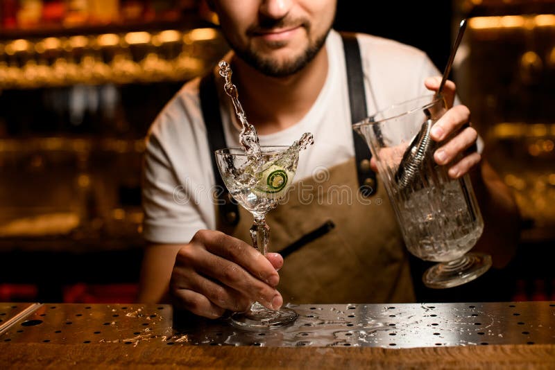Bartender Mixing with Splash an Alcoholic Cocktail with a Cucumber ...