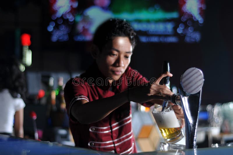 Bartender poring beer stock photo. Image of drink, nightclub - 20788982