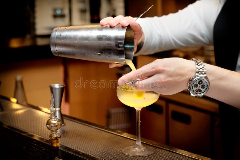 Bartender is Pouring Cocktail from Shaker, Toned Stock Image - Image of ...