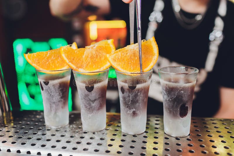 Bartender Pouring Strong Alcoholic Drink into Small Glasses on Bar ...