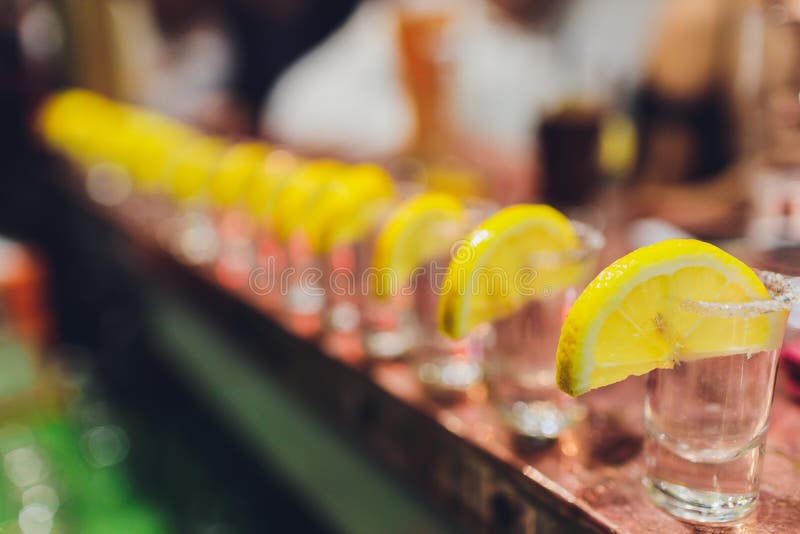 Bartender Pouring Strong Alcoholic Drink into Small Glasses on Bar ...