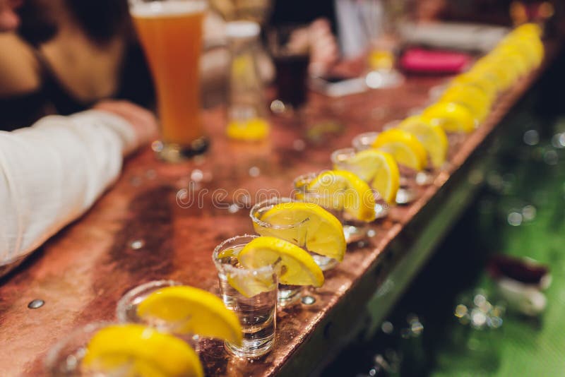 Bartender Pouring Strong Alcoholic Drink into Small Glasses on Bar ...