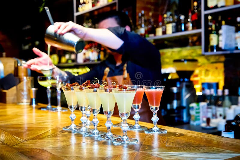 The Bartender Pours Yellow Cocktails into Shots Stock Photo - Image of ...