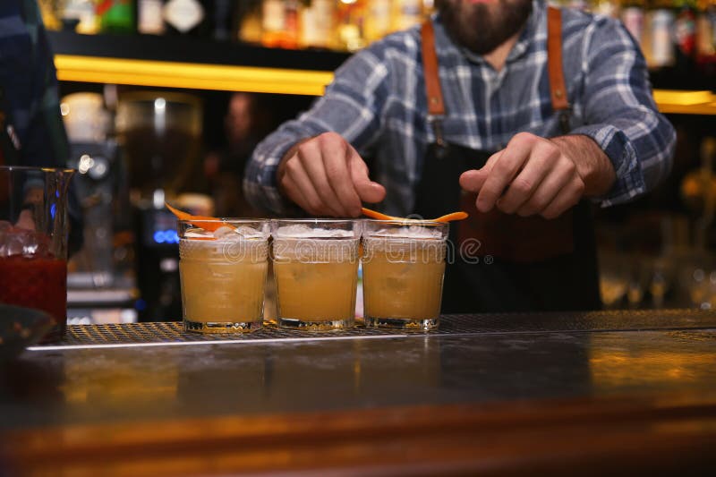 Bartender Preparing Tasty Cocktail at Table in Nightclub Stock Image ...
