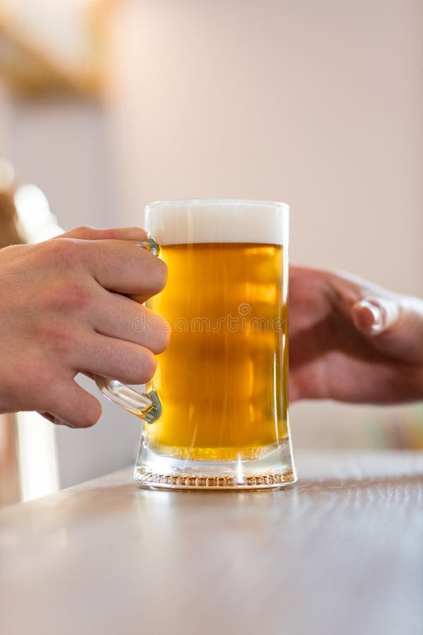 Bartender Serving Beer To Customer at Bar Counter Stock Photo - Image ...