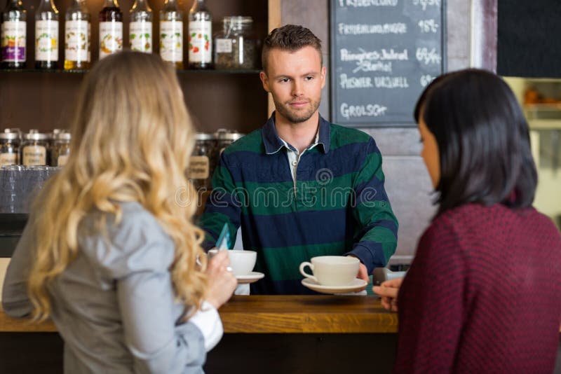 Female Bartender Serving Coffee To Woman Stock Image - Image of coffee ...