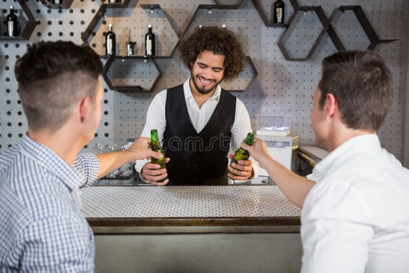 Bartender Serving Glass of Beer To Customers Stock Photo - Image of ...