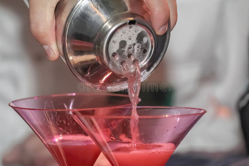 A Bartender Skillfully Crafting a Mixed Drink, Elegantly Pouring it ...