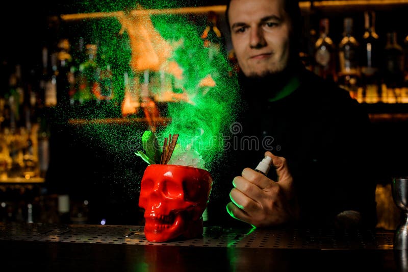 Bartender Spraying on the Cocktail in the Red Scull Cup from the ...