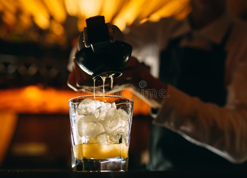 The Bartender Squeezes Citrus Juice into a Cocktail. Stock Photo ...