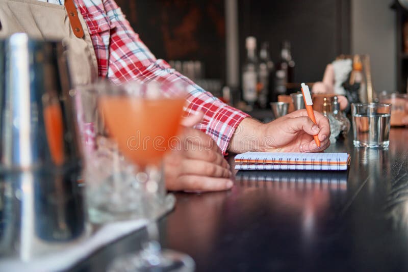 Bartender Standing at Bar Counter Taking Notes Stock Photo - Image of ...