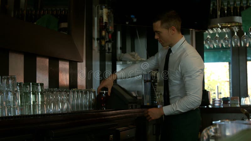Bartender Using Cash Register and Tidying Up the Counter Stock Footage ...