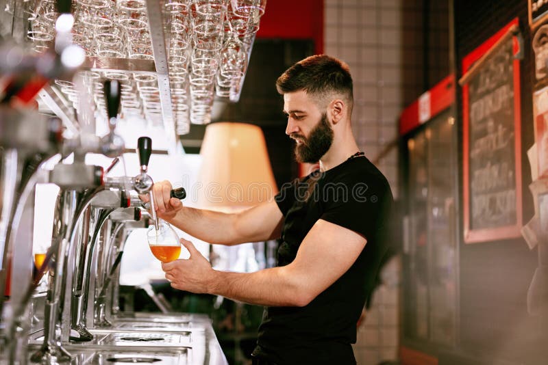 Bartender Working at Bar Pub Pouring Beer in Glass Stock Photo - Image ...