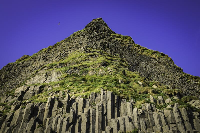 Basalt Columns Forming a Mountain Peak Beneath a Blue Sky Stock Photo ...