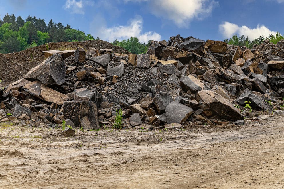 Basalt Stones in a Quarry. Columnar Basalt Quarry in Summer Stock Photo ...