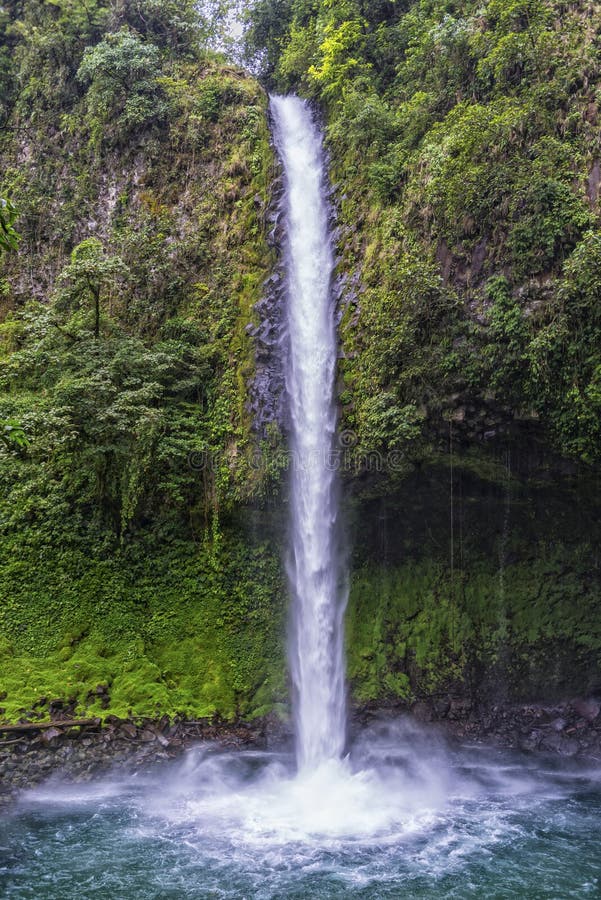 The Base of a Waterfall Near Water on a Rainy Day Stock Image - Image ...