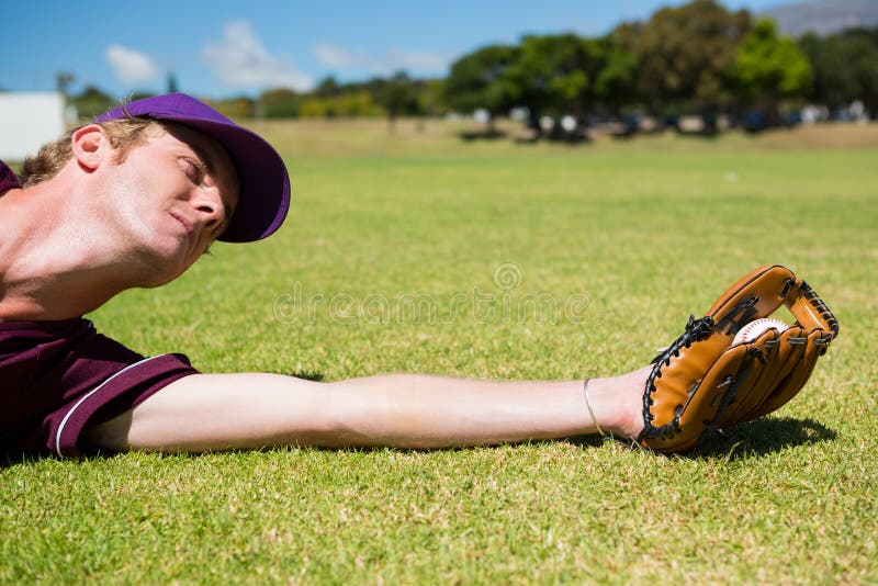 Baseball Pitcher Catching Ball while Diving on Field Stock Photo ...