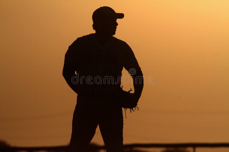 Baseball pitcher at sunset editorial image. Image of small - 151812730