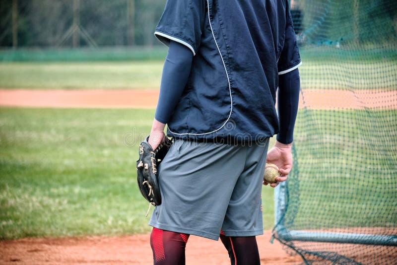 Baseball Player Holding Ball and Watching the Game Stock Photo - Image ...