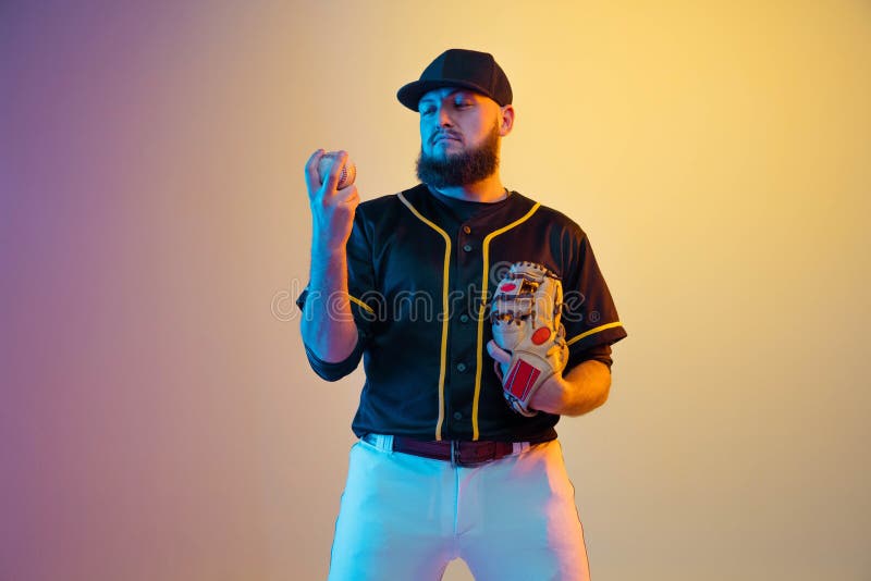 Baseball Player, Pitcher in a Black Uniform Practicing on Gradient ...