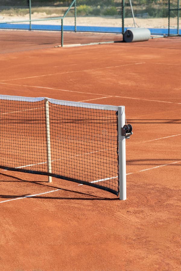 Baseline and Net of an Empty Clay Tennis Court on a Sunny Day Stock ...