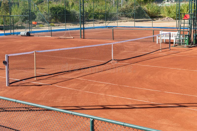Baseline and Net of an Empty Clay Tennis Court on a Sunny Day Stock ...