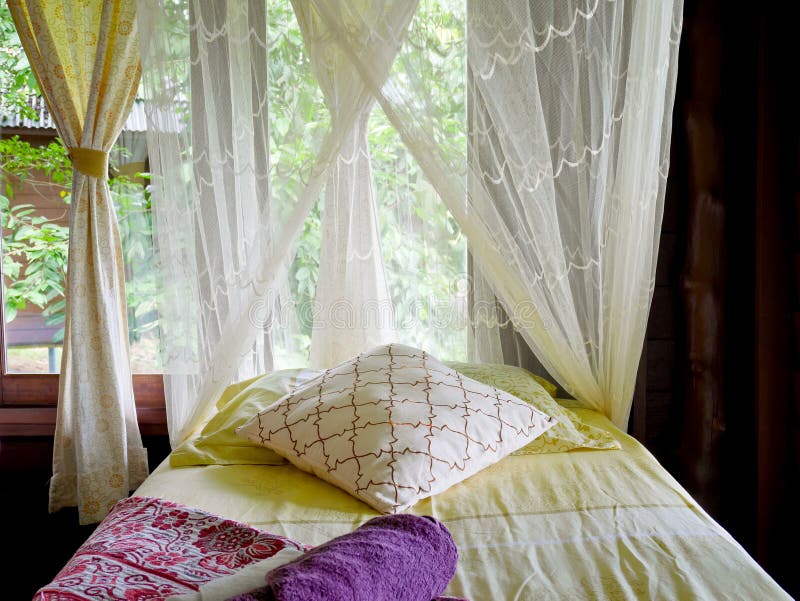 Basic Amenities on a Bed with Mosquito Net Stock Image - Image of ...