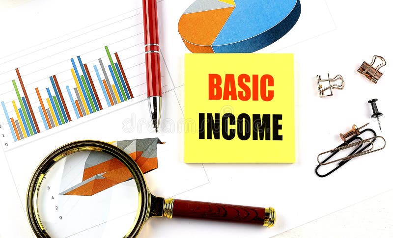 BASIC INCOME Text on Yellow Sticky on Chart with Magnifier and Pen ...