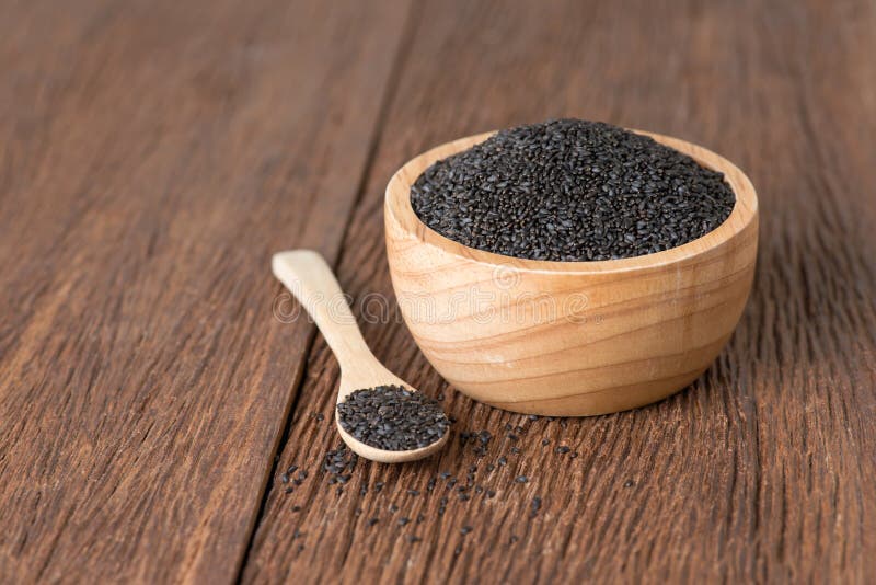 Basil seeds in wood bowl. stock image. Image of closeup - 94905381