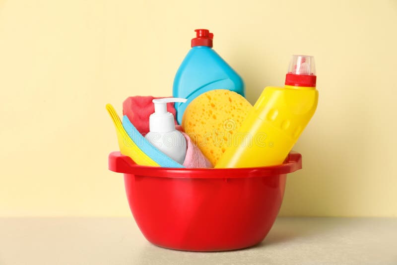 Basin with Different Cleaning Supplies on Light Floor Near Beige Wall ...