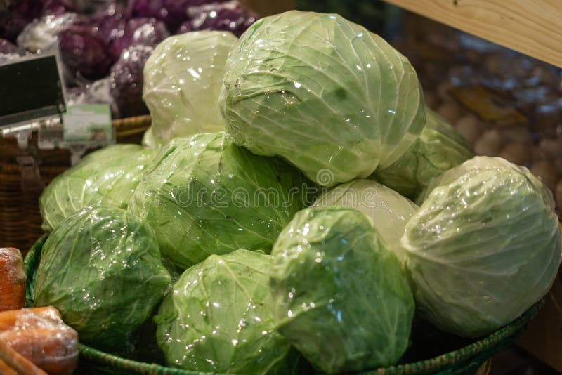 Basket with Cabbage Heads Wrapped in Plastic in Shop Stock Photo ...