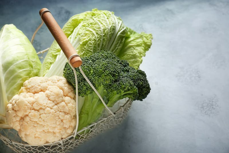 Basket with Different Kinds of Cabbage on Color Table Stock Image ...