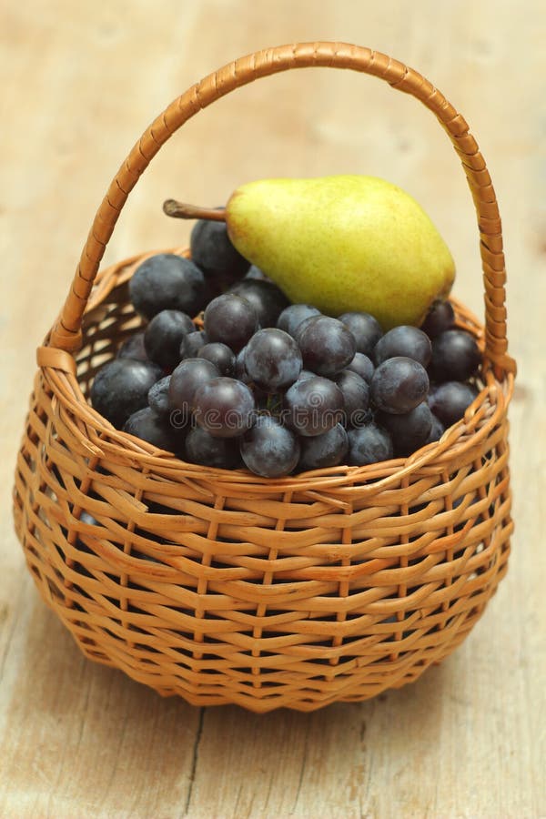 Basket Full of Grapes with Pear on Top Stock Photo - Image of bunch ...